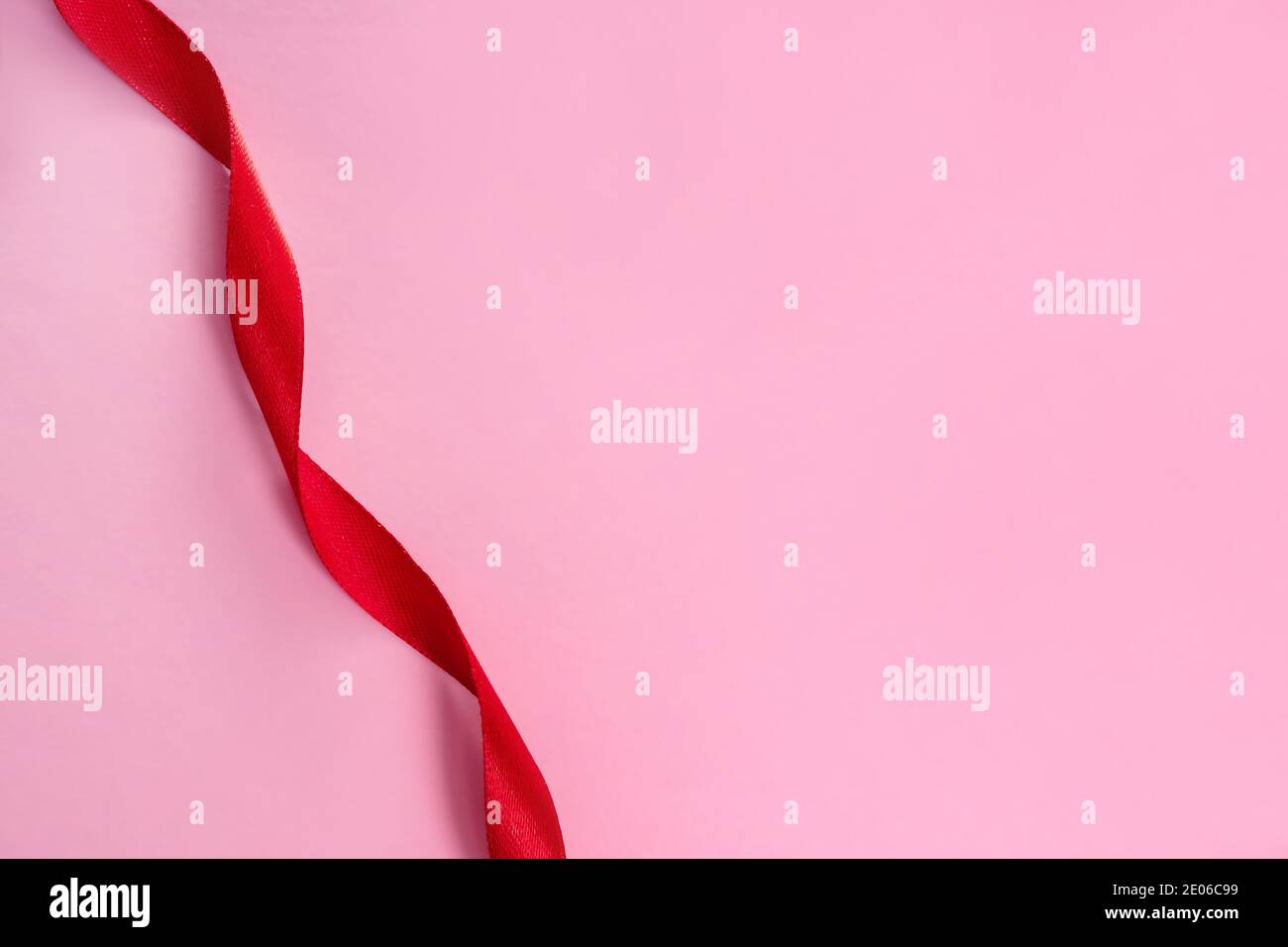 Red shiny ribbon on pink background Stock Photo - Alamy