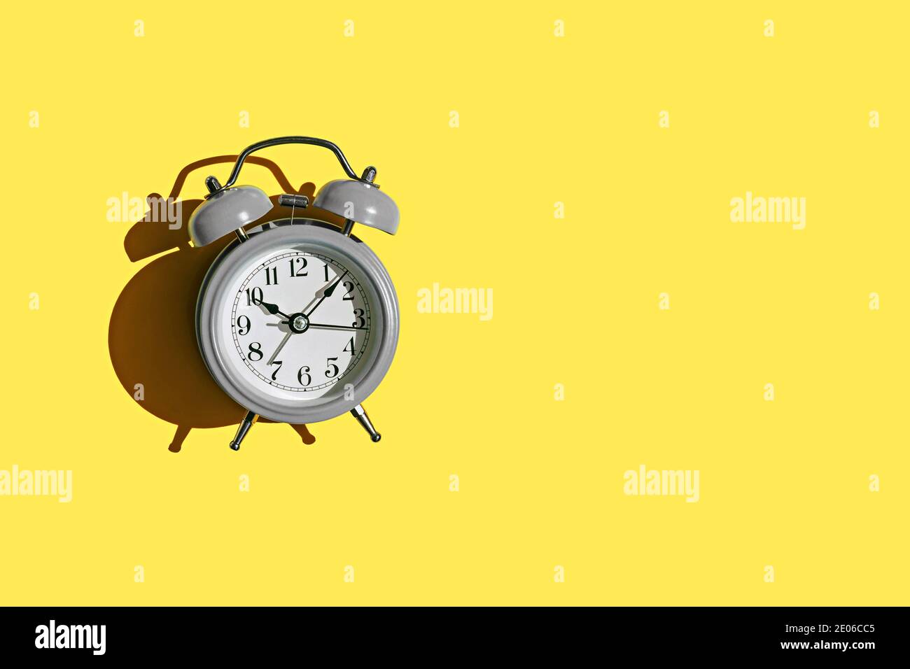 Grey alarm clock on yellow background with copy space. Color 2021. Top ...