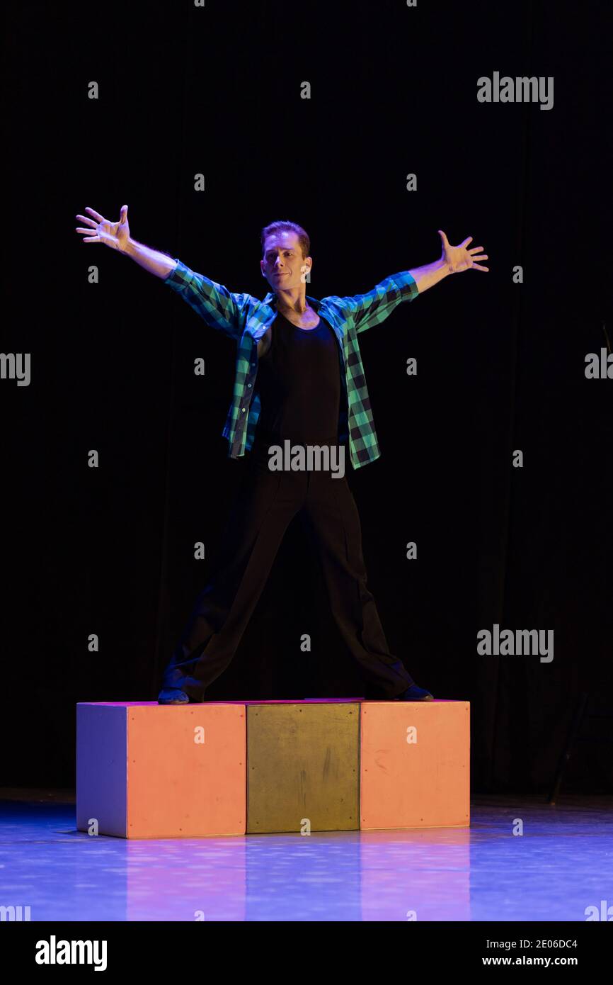 Actor dancer young man performs in the theater on stage in a dance ...