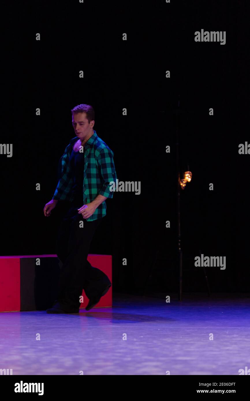 Actor dancer young man performs in the theater on stage in a dance ...