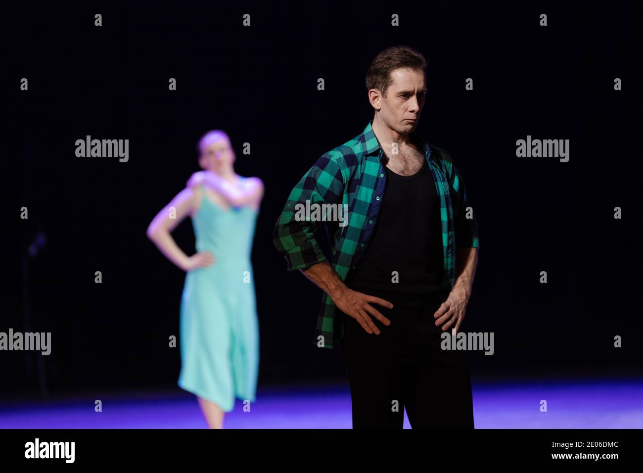 A pair of dancers a man and a woman perform in a theater on stage in a ...