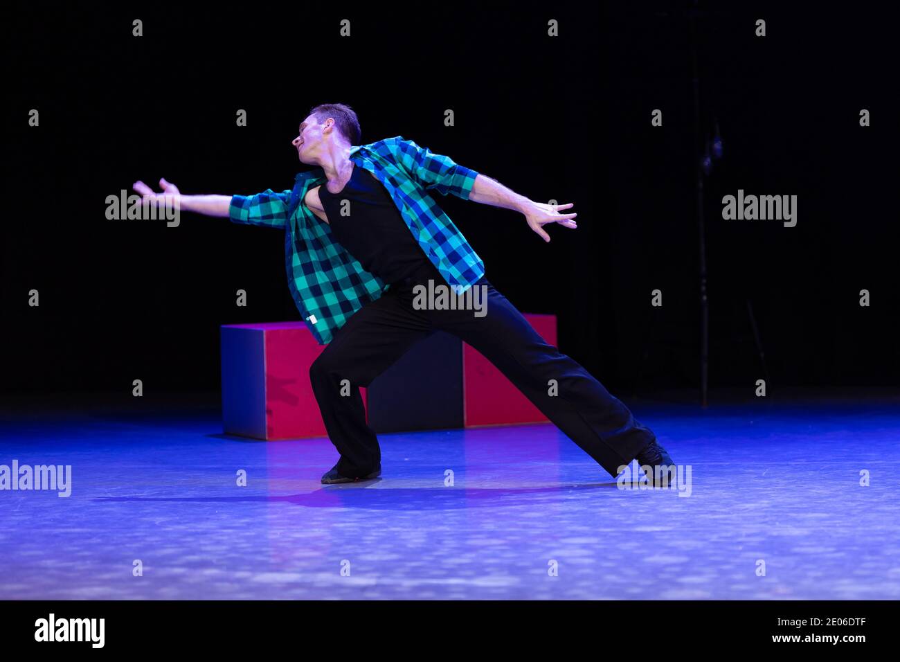 A pair of dancers a man and a woman perform in a theater on stage in a ...