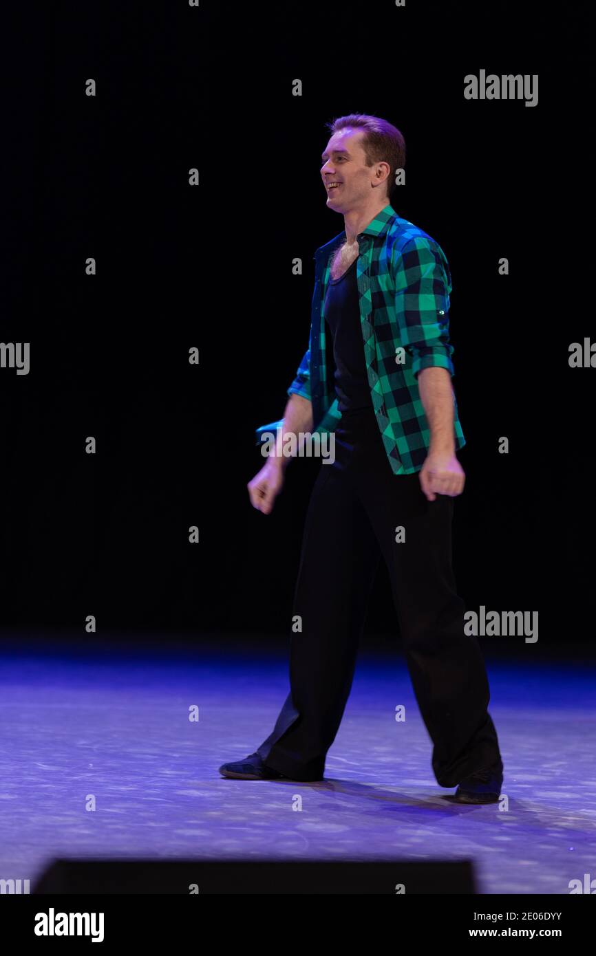 Actor dancer young man performs in the theater on stage in a dance ...