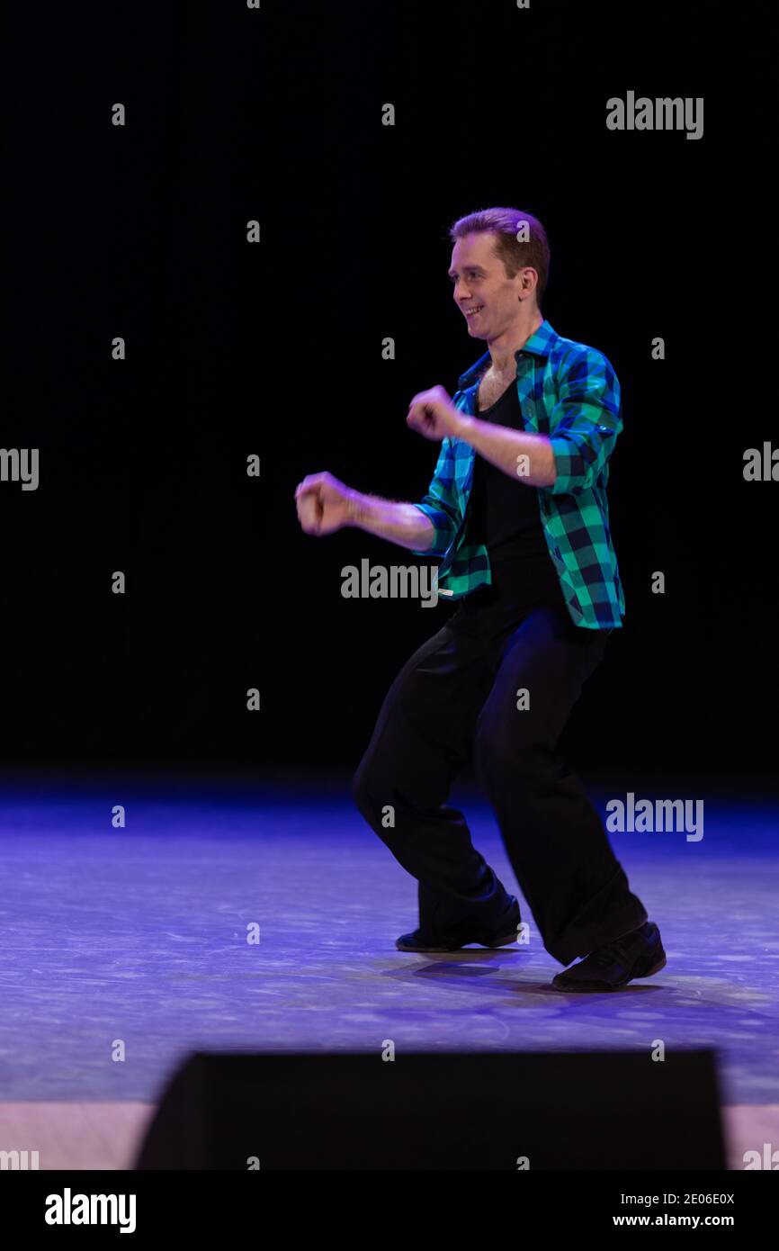 Actor dancer young man performs in the theater on stage in a dance ...
