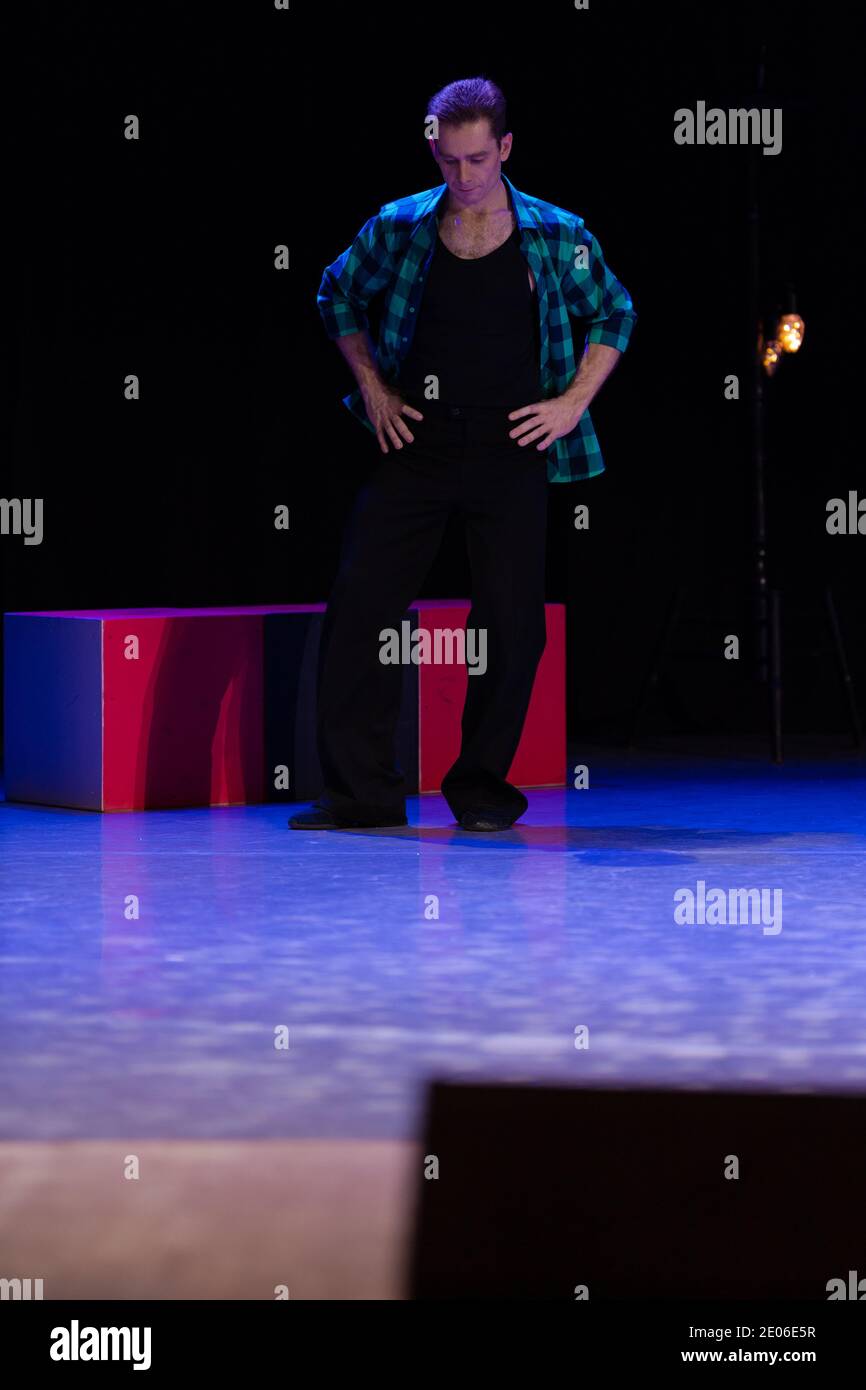 Actor dancer young man performs in the theater on stage in a dance ...