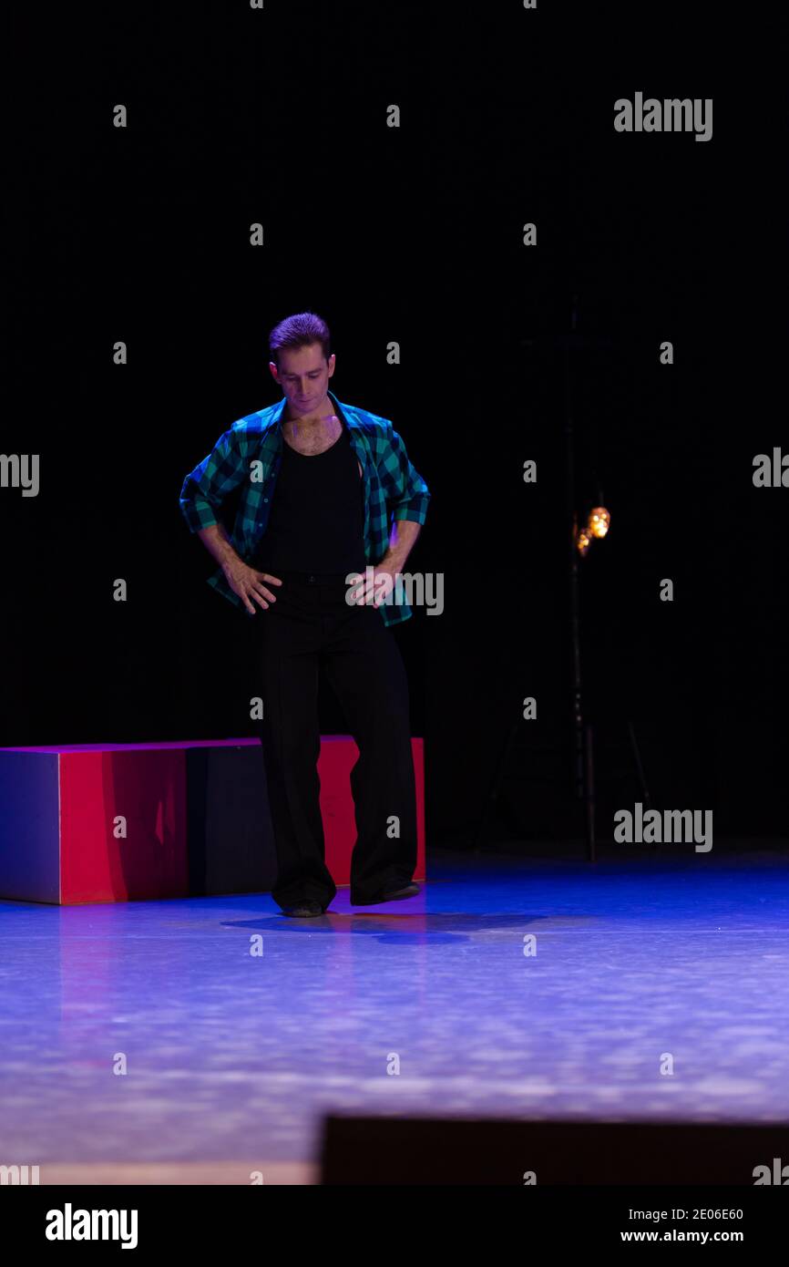 Actor dancer young man performs in the theater on stage in a dance ...