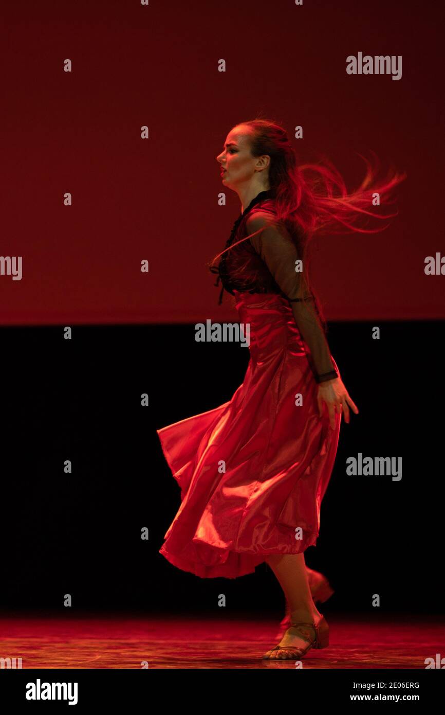 Dancer in a red dress dancing Spanish flamenco on the stage in the ...