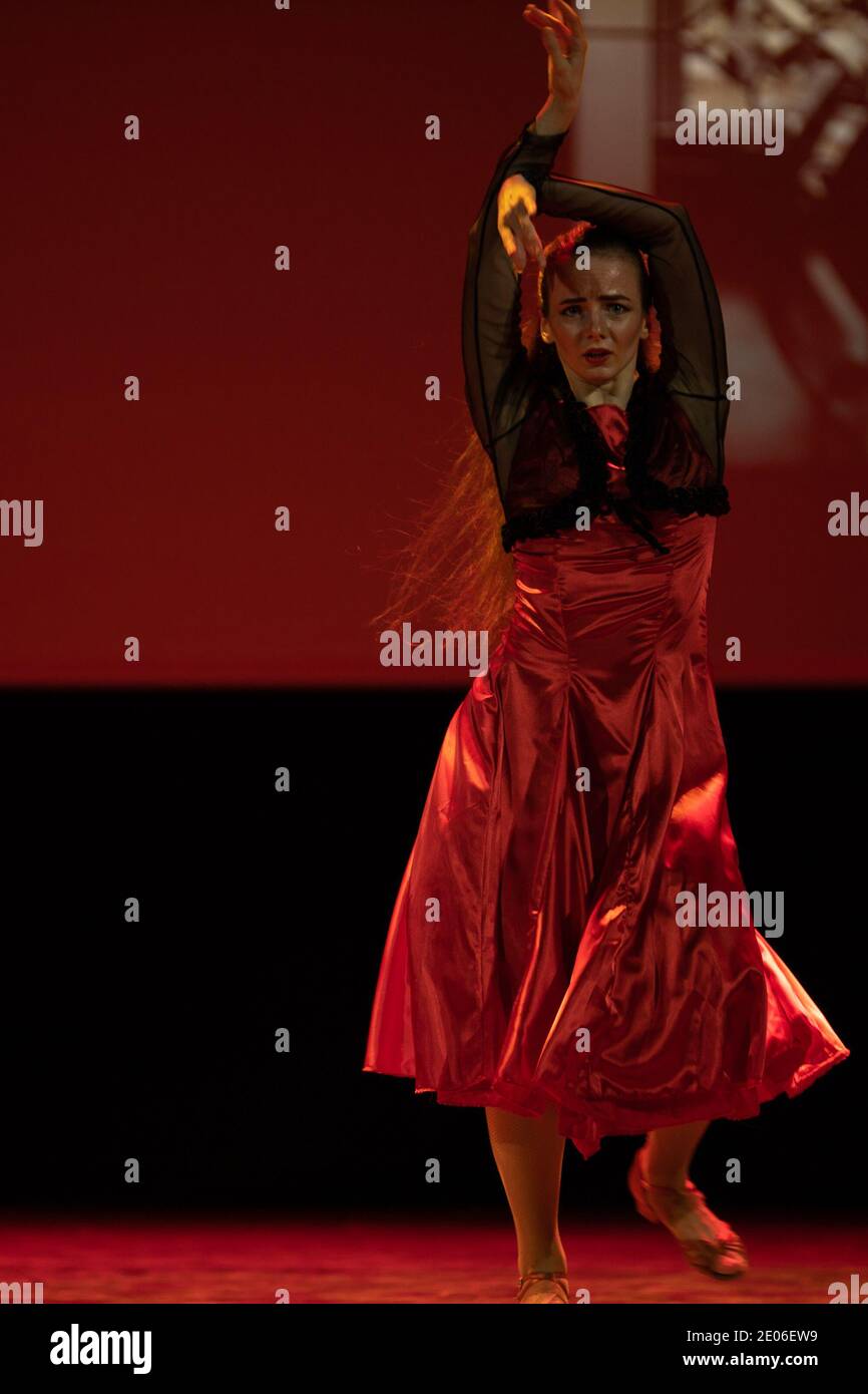Dancer in a red dress dancing Spanish flamenco on the stage in the ...
