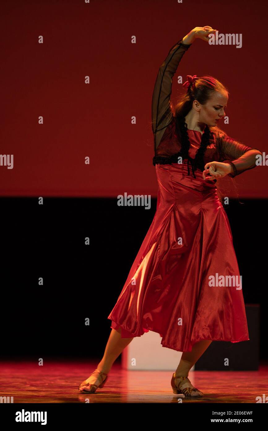 Dancer in a red dress dancing Spanish flamenco on the stage in the ...