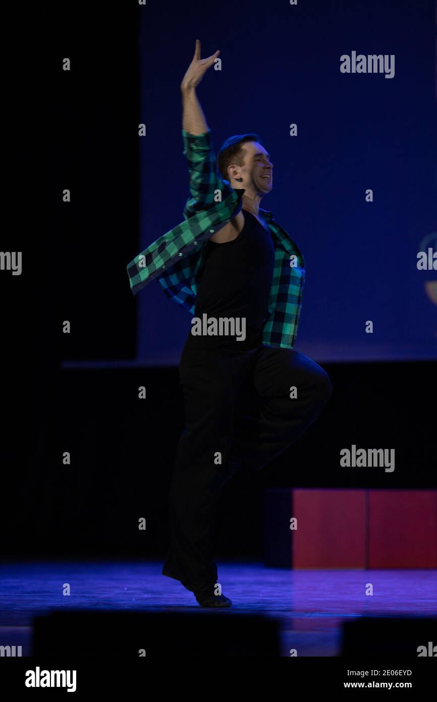 Actor dancer young man performs in the theater on stage in a dance ...