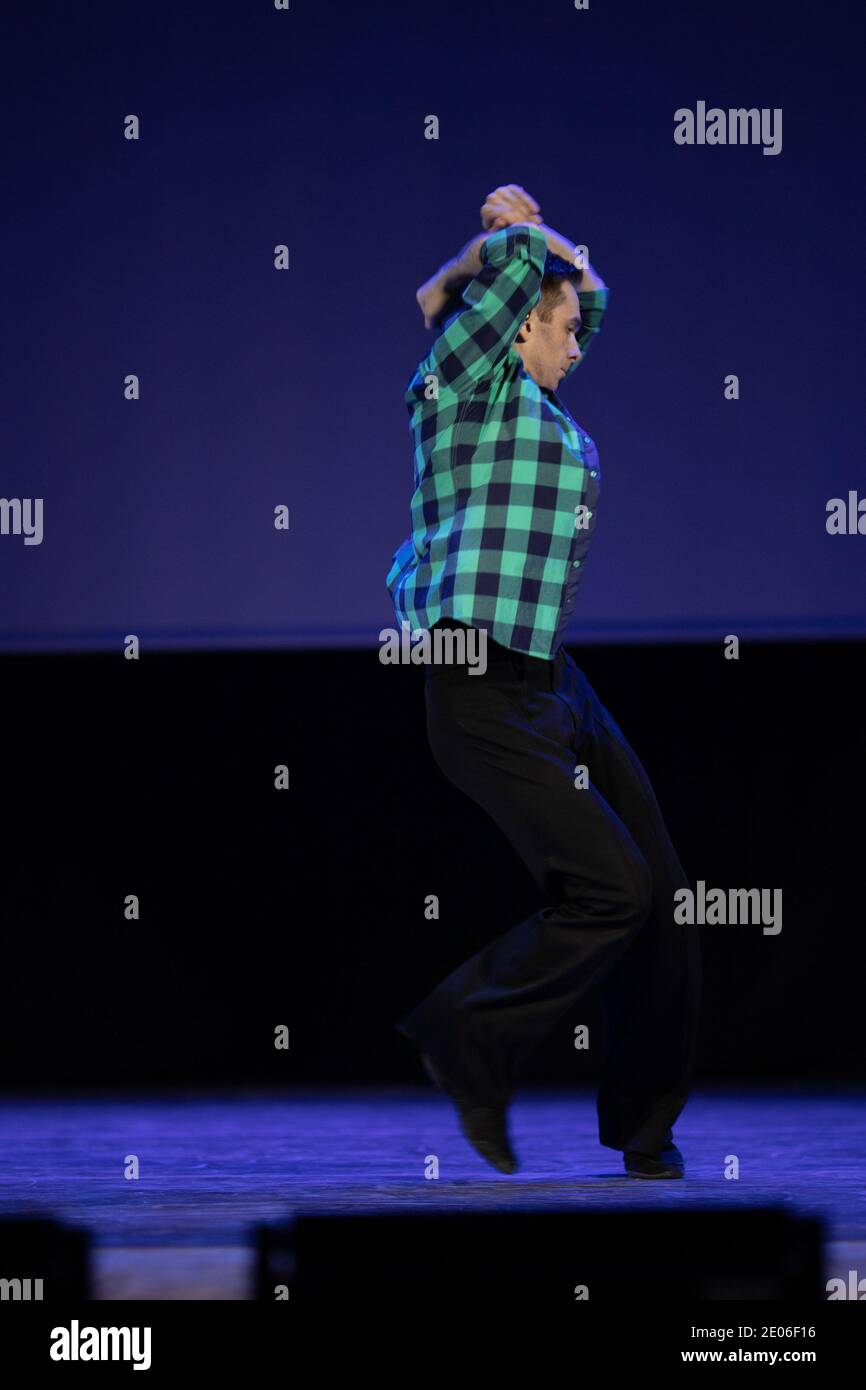 Actor dancer young man performs in the theater on stage in a dance ...