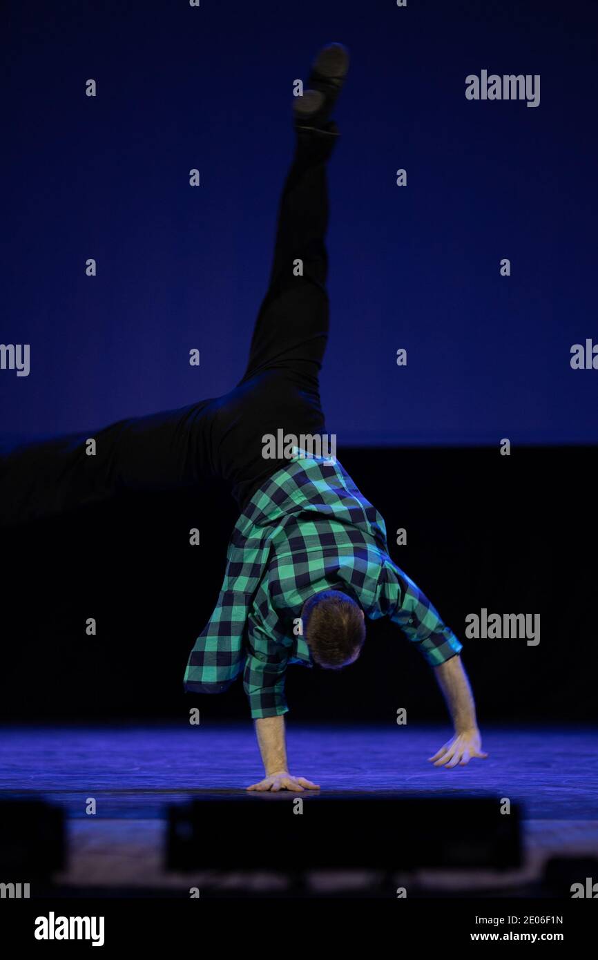 Actor dancer young man performs in the theater on stage in a dance ...