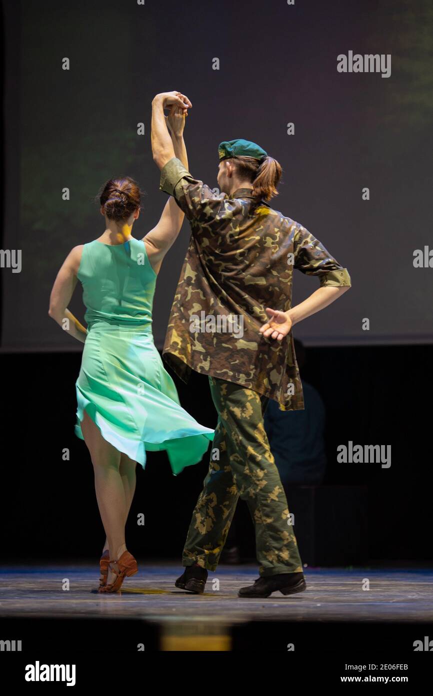Team Actors dancers perform in the theater on stage in a retro musical ...