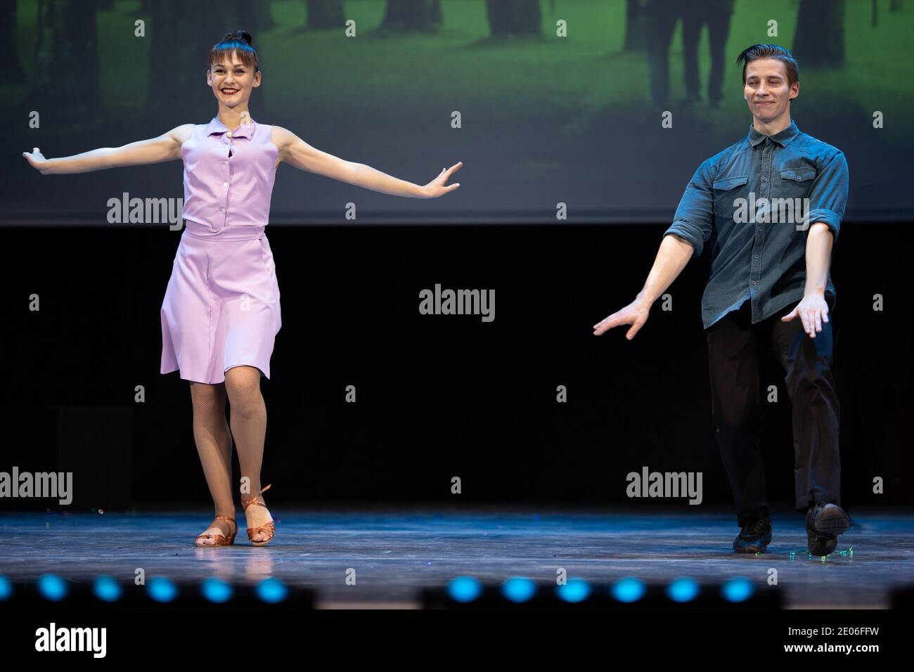 Team Actors dancers perform in the theater on stage in a retro musical ...