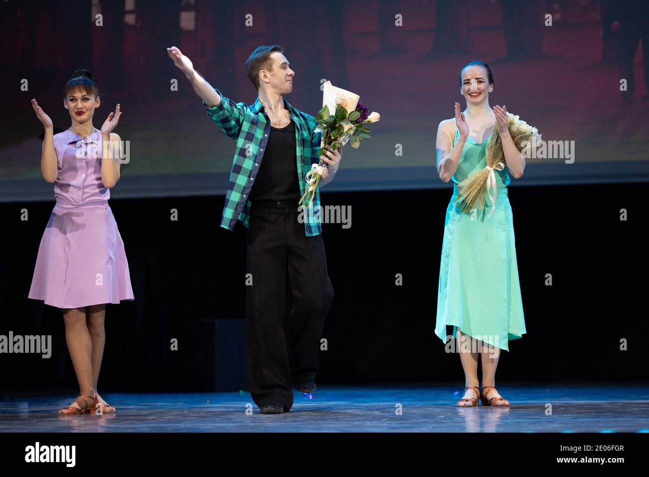Team Actors dancers perform in the theater on stage in a retro musical ...