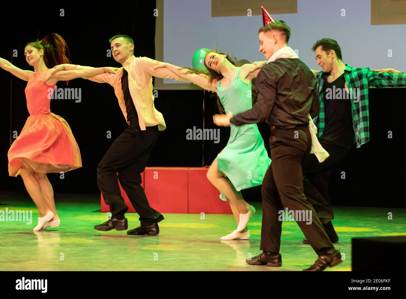 Team Actors dancers perform in the theater on stage in a retro musical ...