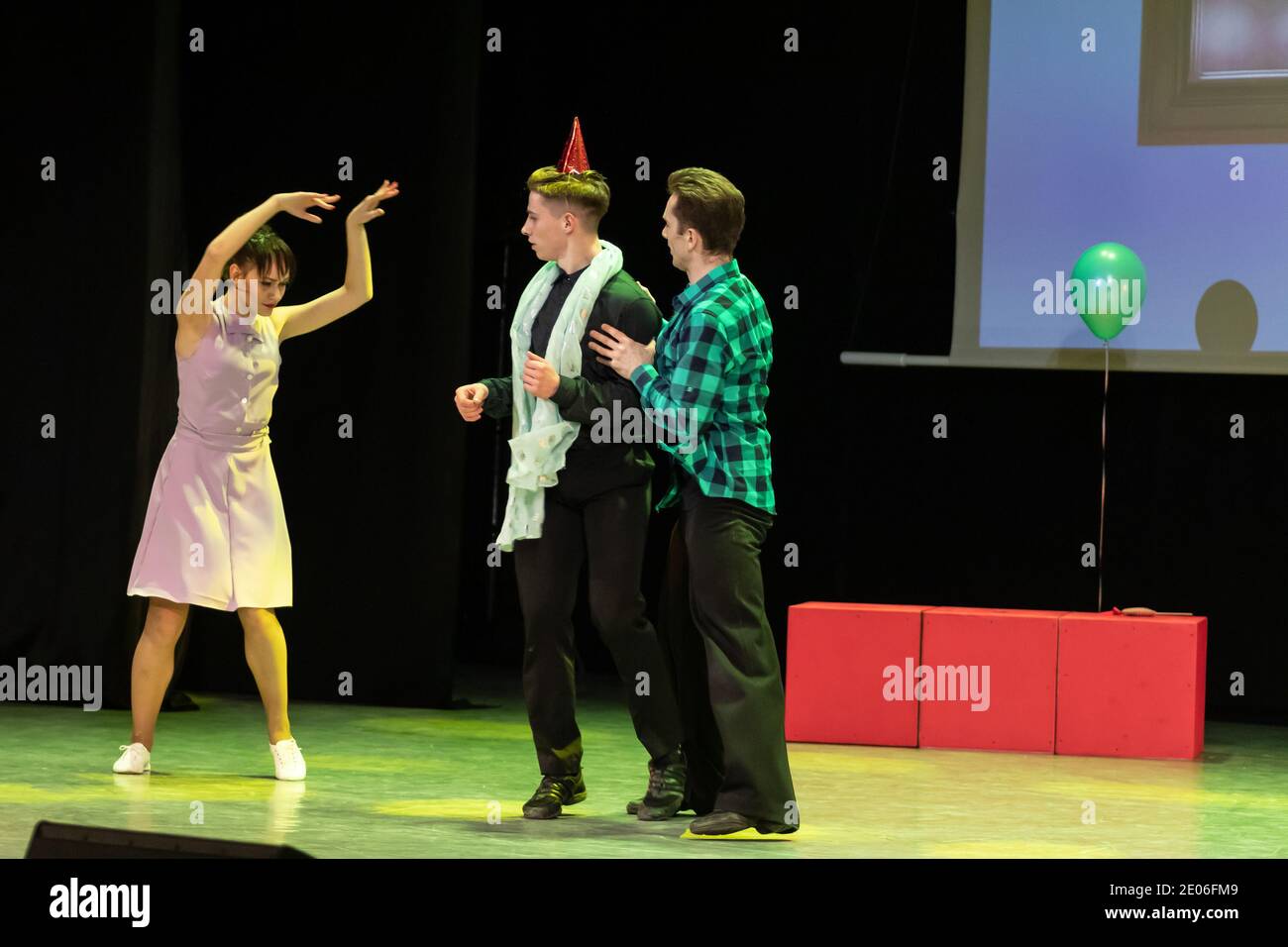 Team Actors dancers perform in the theater on stage in a retro musical ...