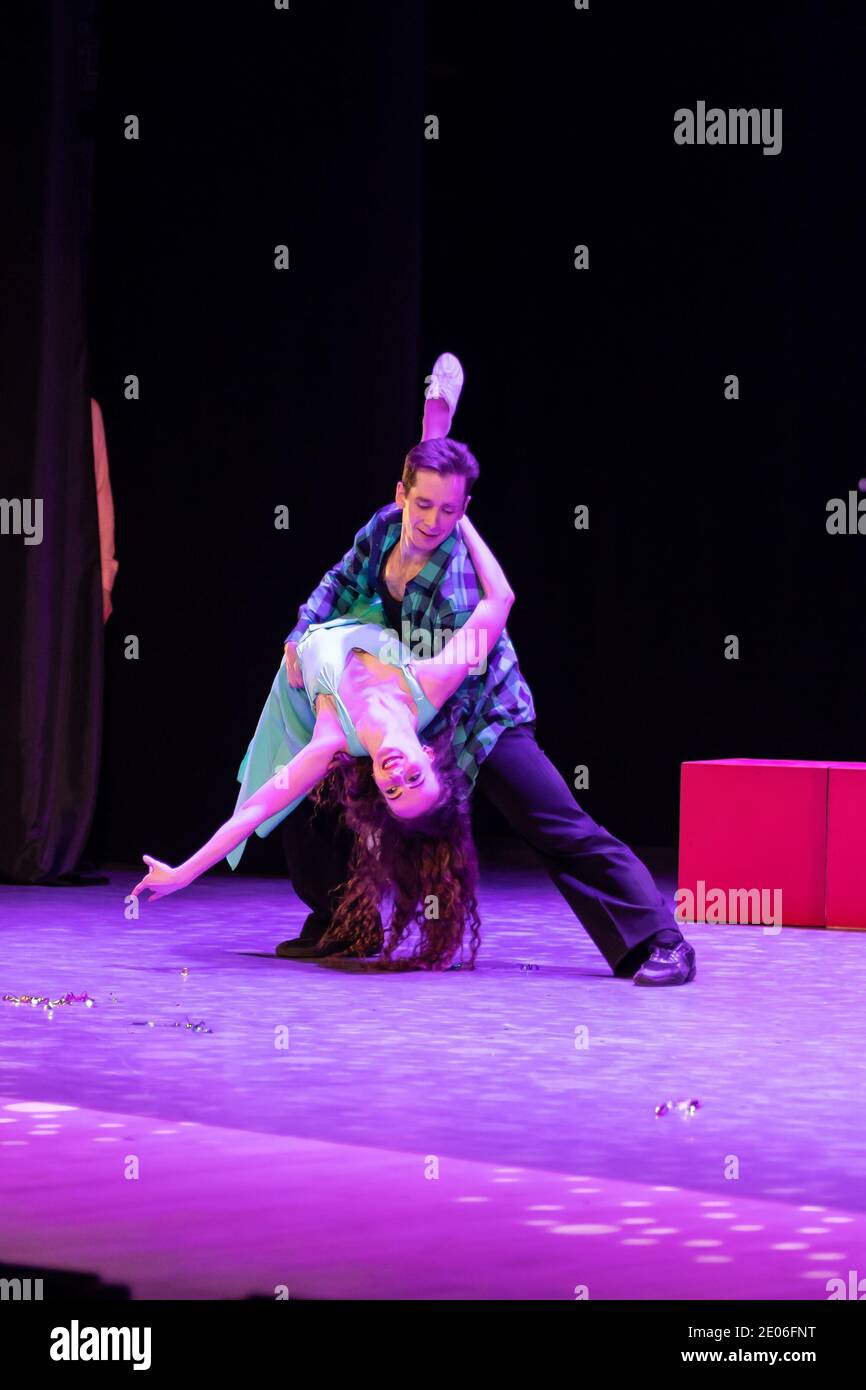 Team Actors dancers perform in the theater on stage in a retro musical ...