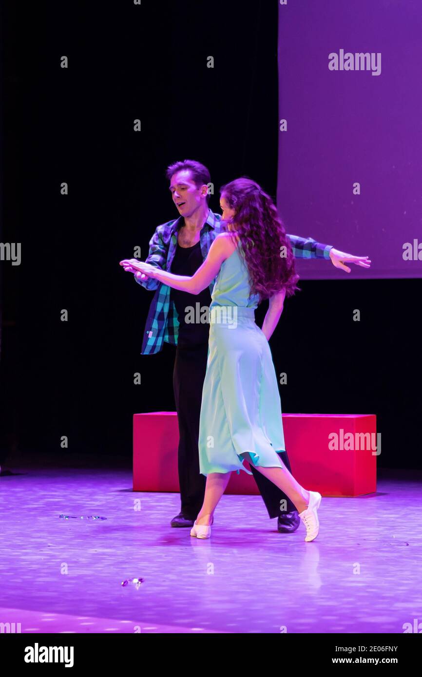 Team Actors dancers perform in the theater on stage in a retro musical ...