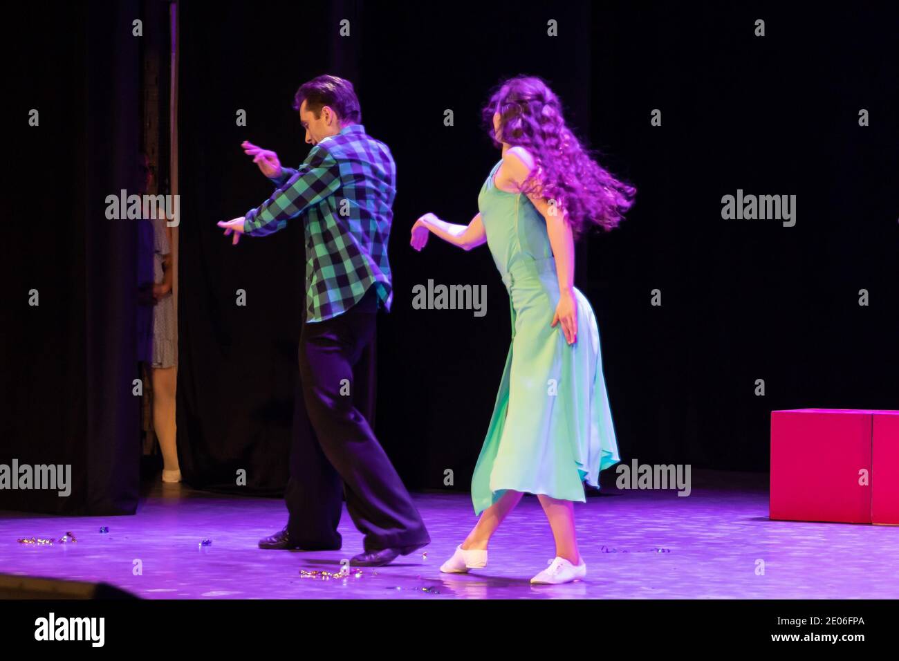 Team Actors dancers perform in the theater on stage in a retro musical ...