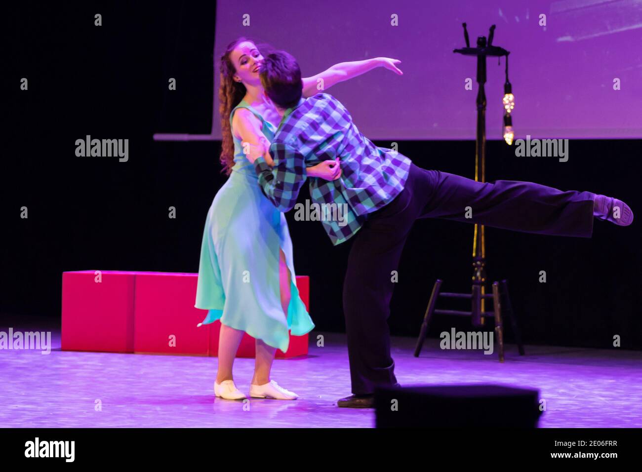 Team Actors dancers perform in the theater on stage in a retro musical ...