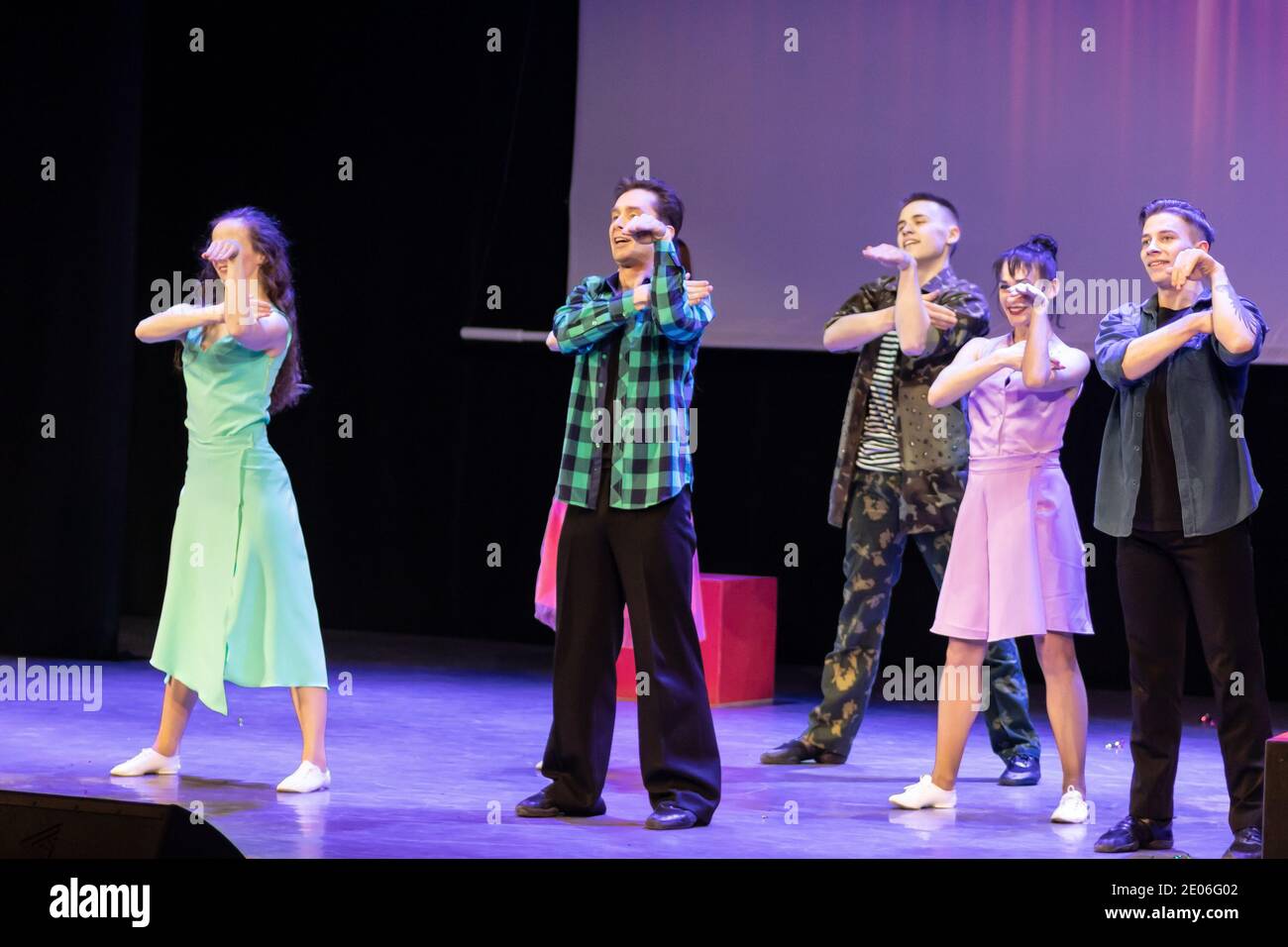 Team Actors dancers perform in the theater on stage in a retro musical ...