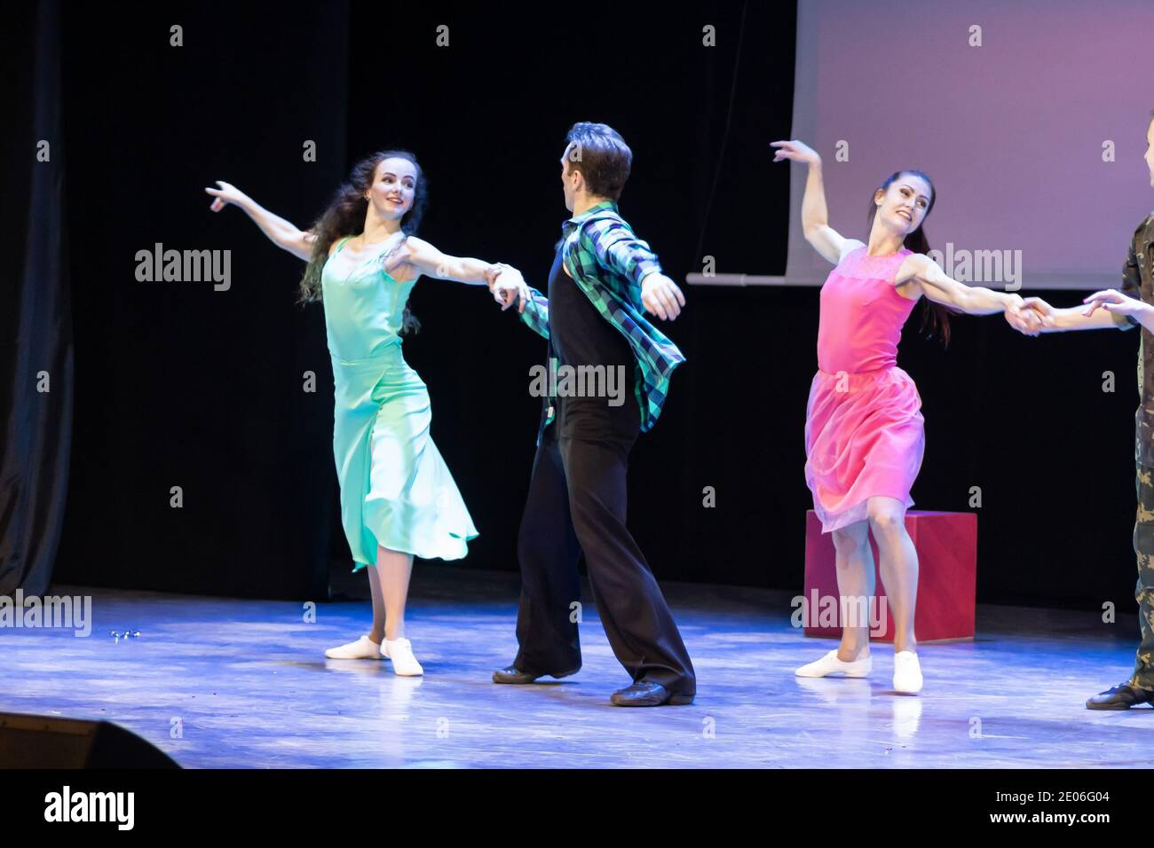 Team Actors dancers perform in the theater on stage in a retro musical ...