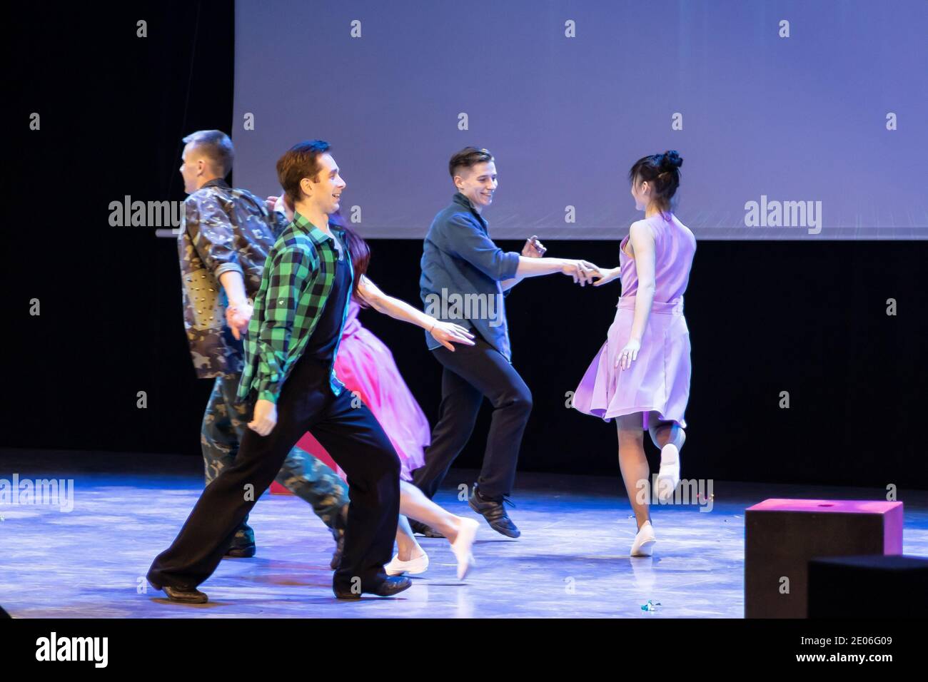 Team Actors dancers perform in the theater on stage in a retro musical ...