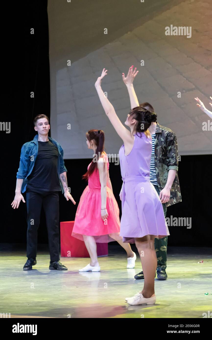 Team Actors dancers perform in the theater on stage in a retro musical ...