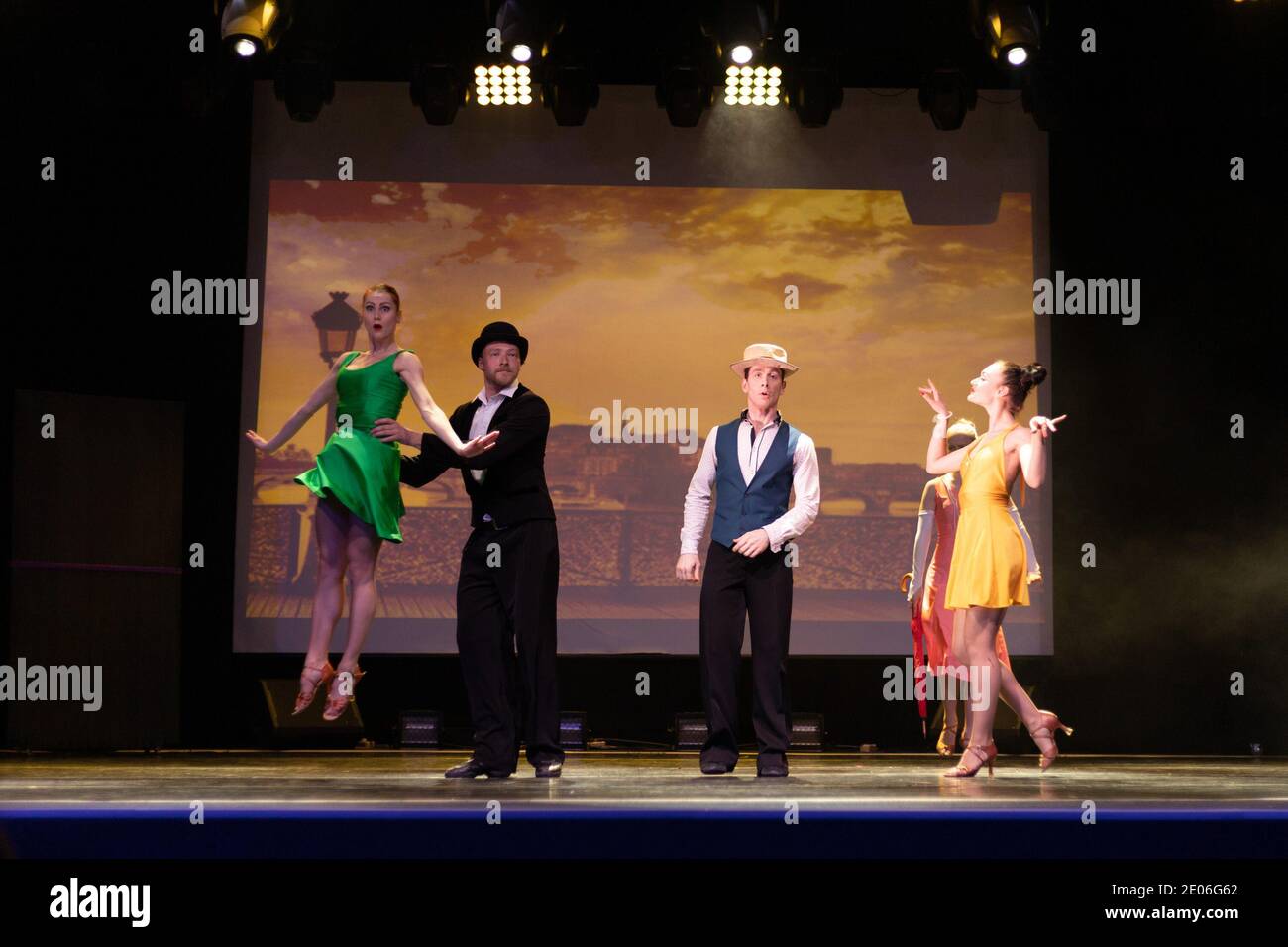 Team Actors dancers perform in the theater on stage in a retro musical ...
