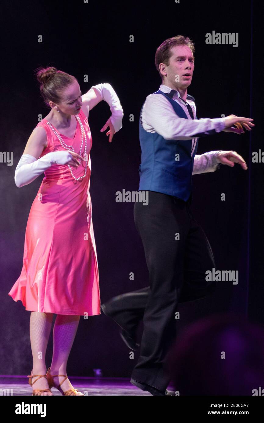 Team Actors dancers perform in the theater on stage in a retro musical ...