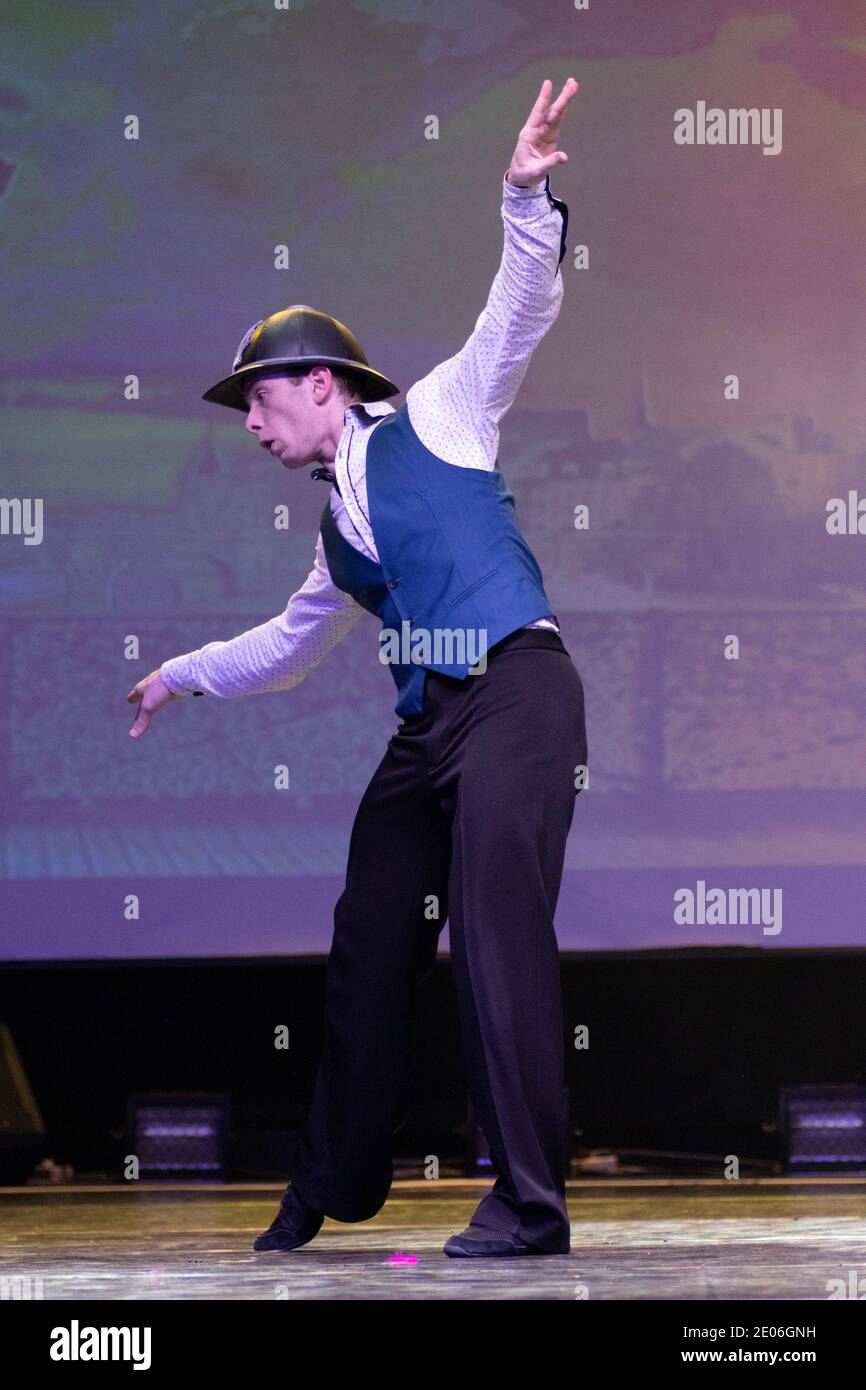 Actor dancer young man performs in the theater on stage in a retro ...