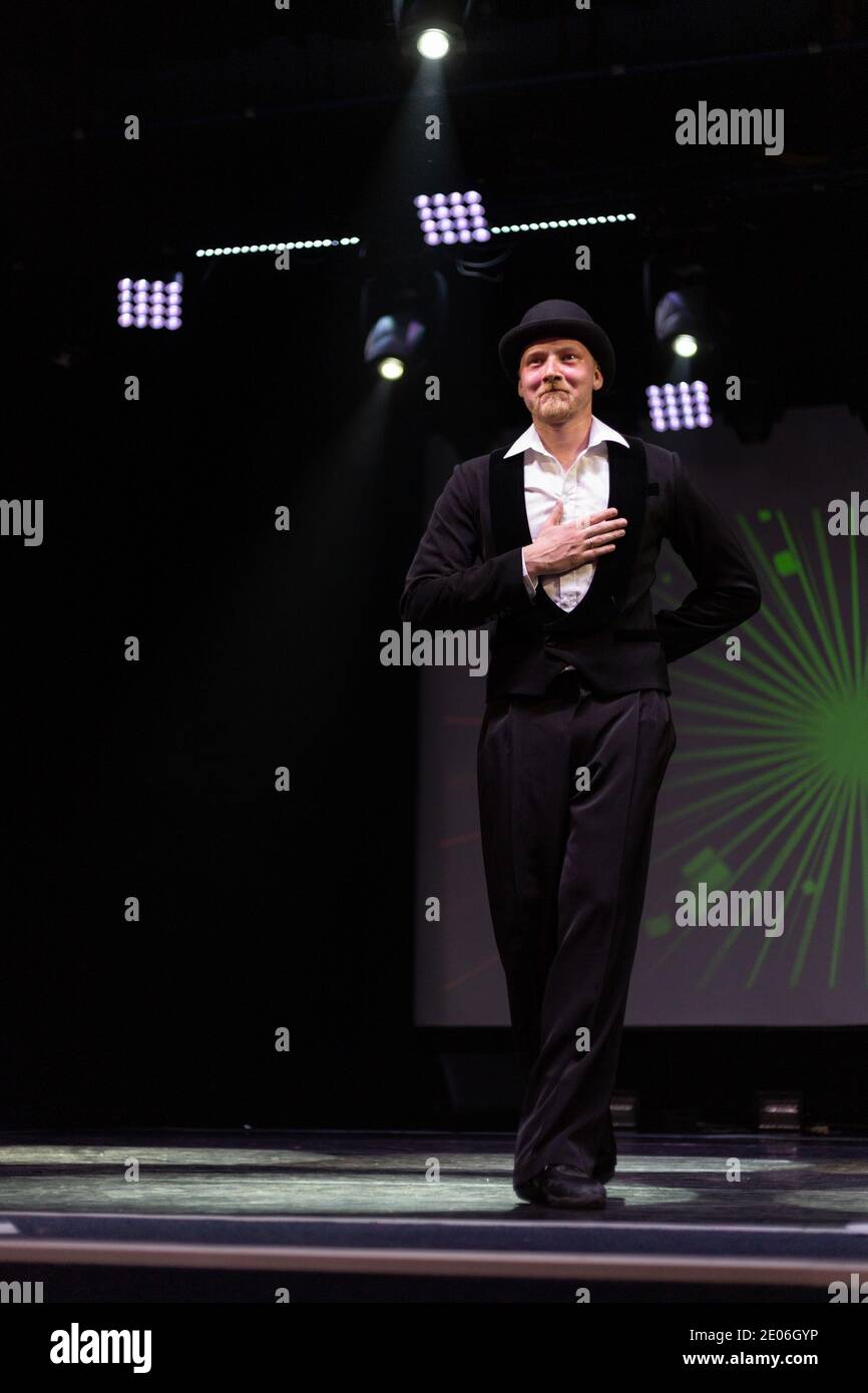 Actor dancer young man performs in the theater on stage in a retro ...