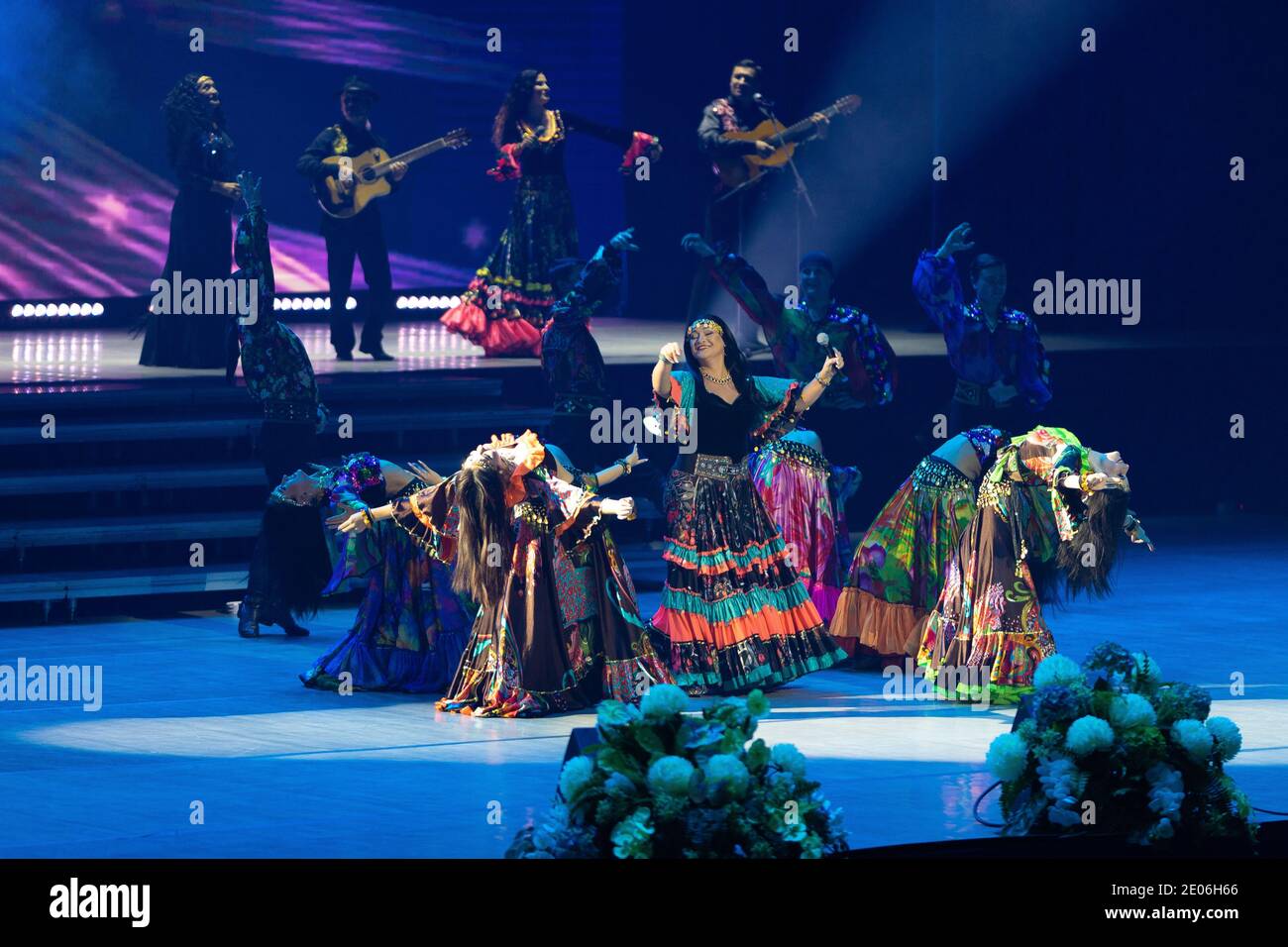 A team of musicians, singers and dancers in gypsy costumes singing and ...