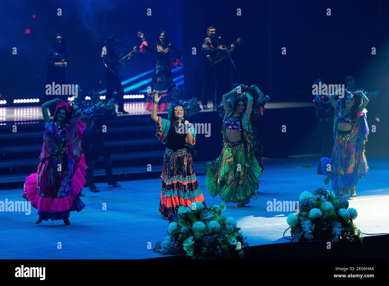 A team of musicians, singers and dancers in gypsy costumes singing and ...