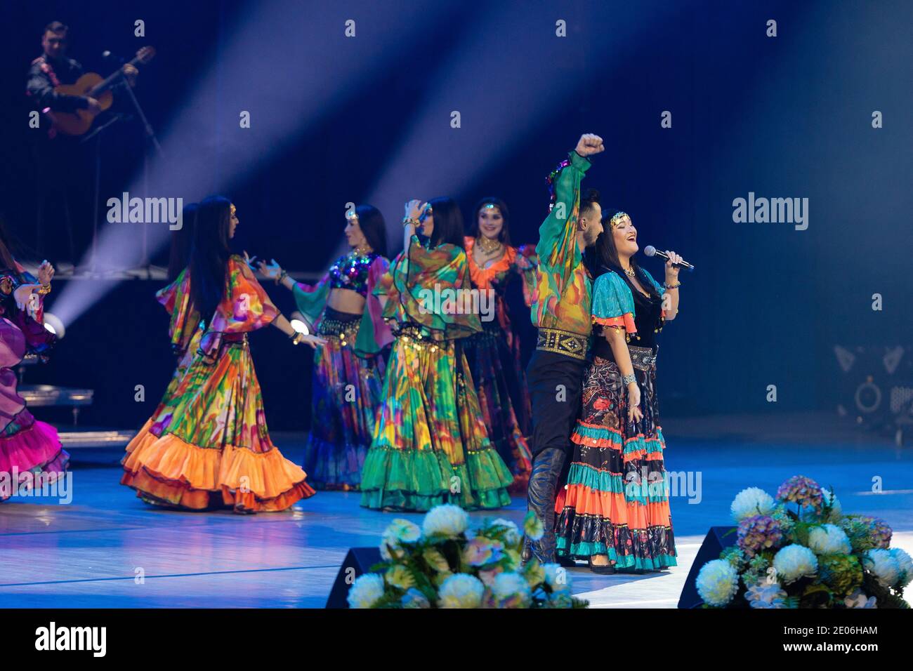 A team of musicians, singers and dancers in gypsy costumes singing and ...