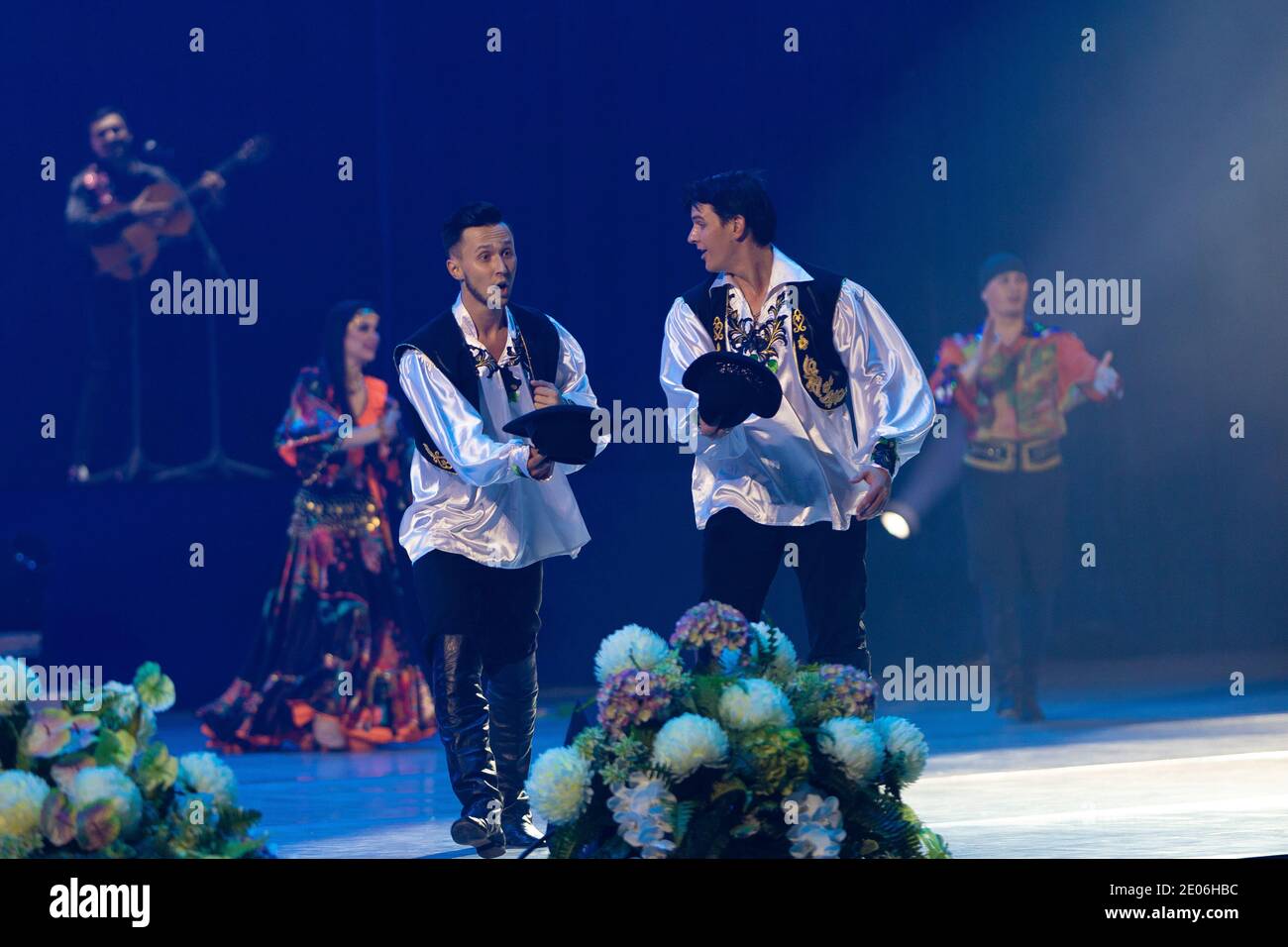 A team of musicians, singers and dancers in gypsy costumes singing and ...