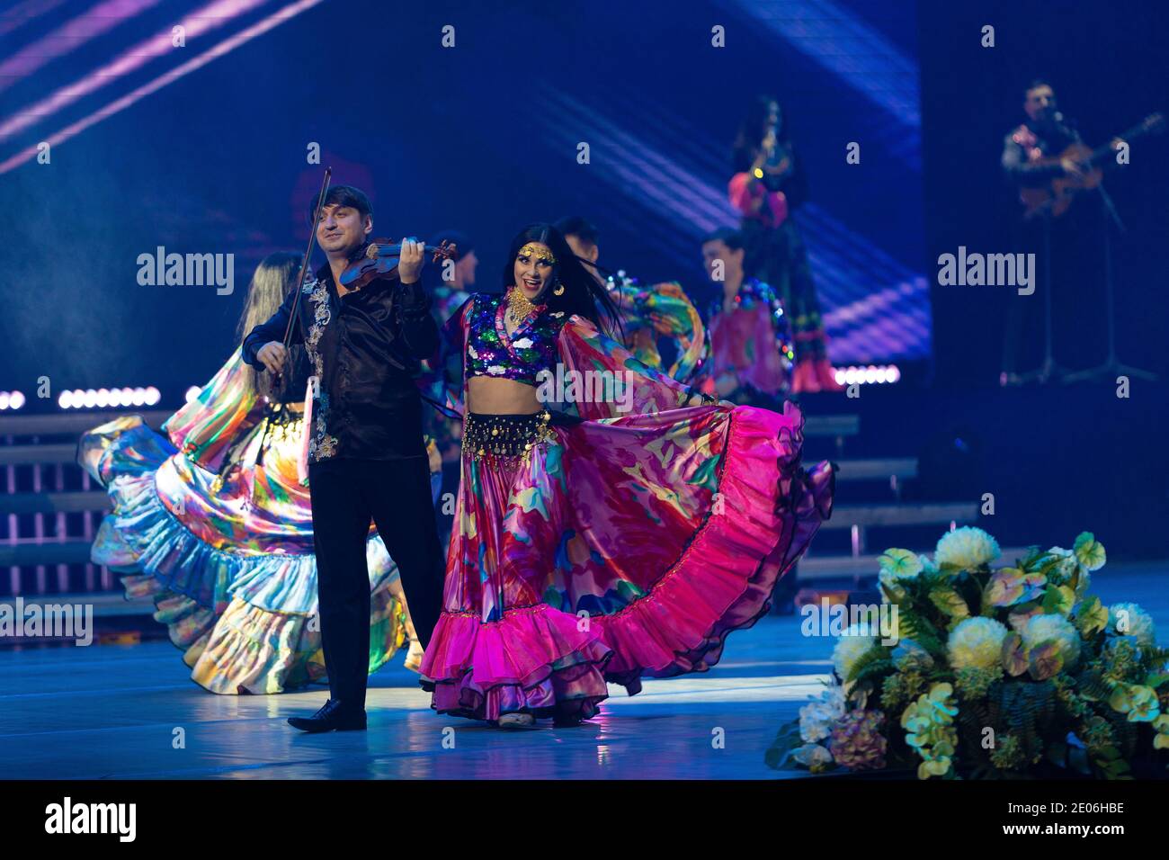 A team of musicians, singers and dancers in gypsy costumes singing and ...