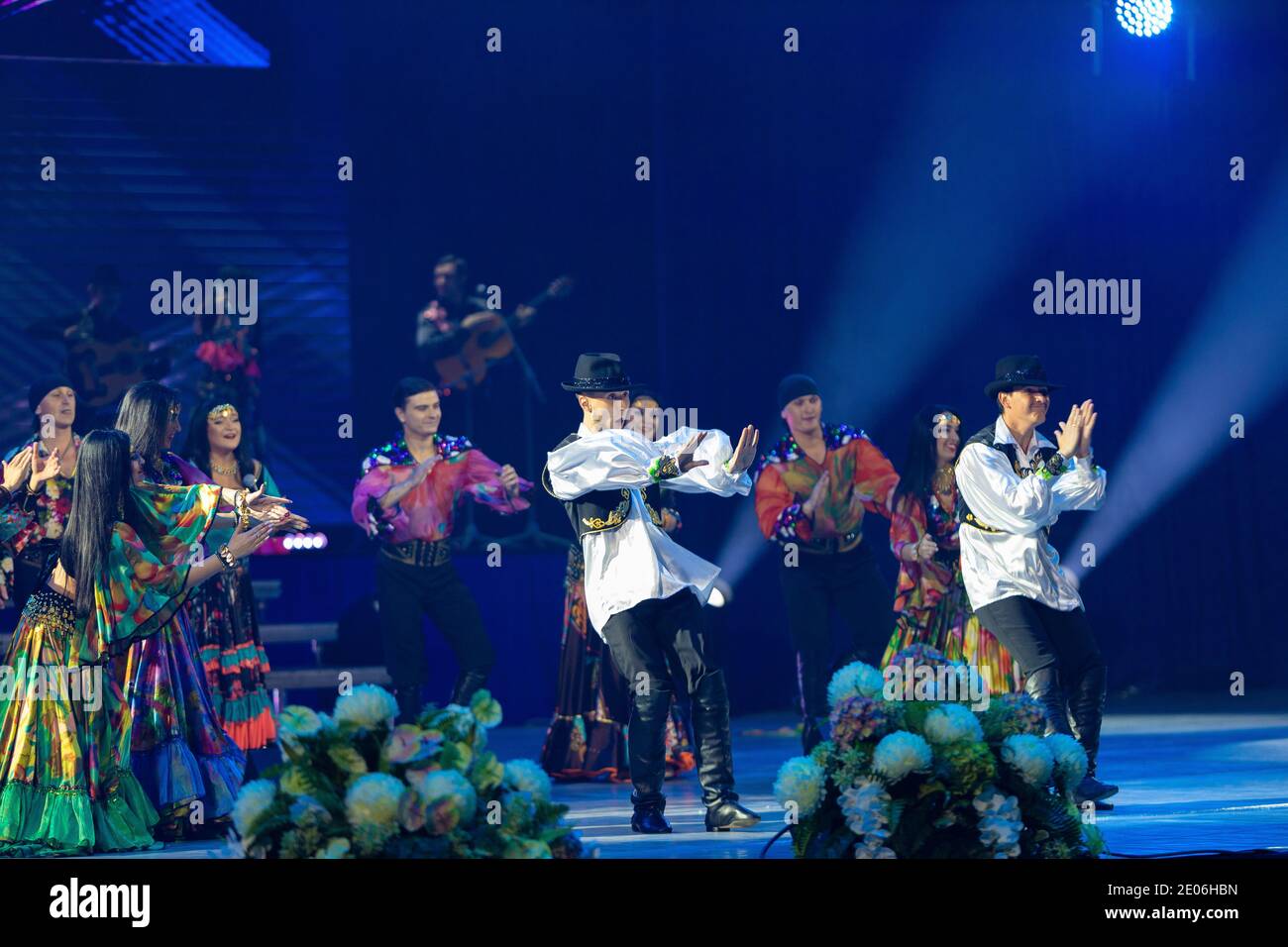 A team of musicians and singers perform on stage in front of the ...