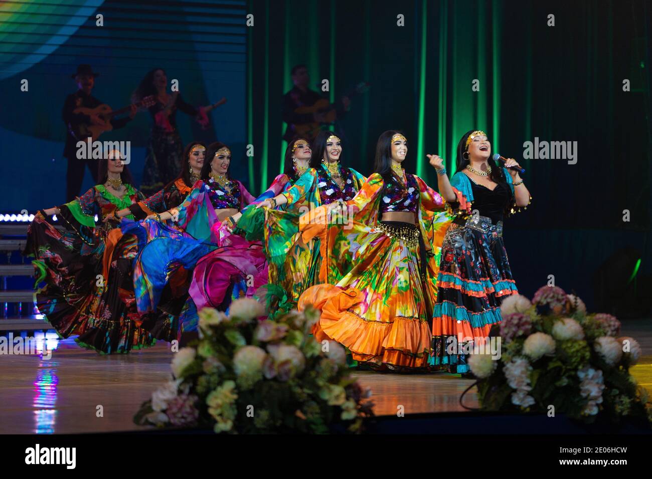 A team of musicians, singers and dancers in gypsy costumes singing and ...