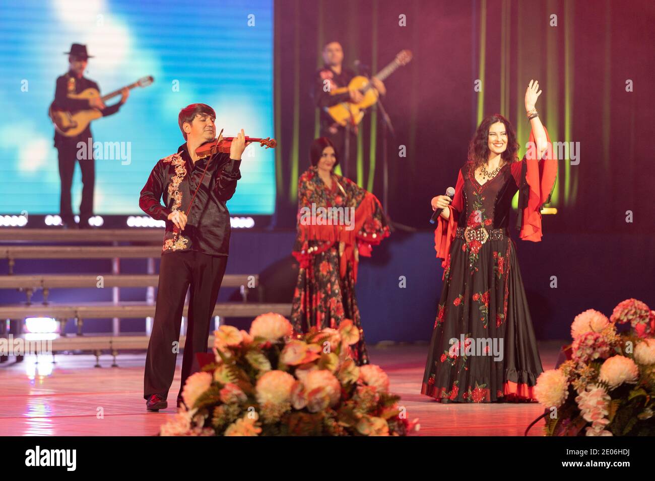 A team of musicians, singers and dancers in gypsy costumes singing and ...
