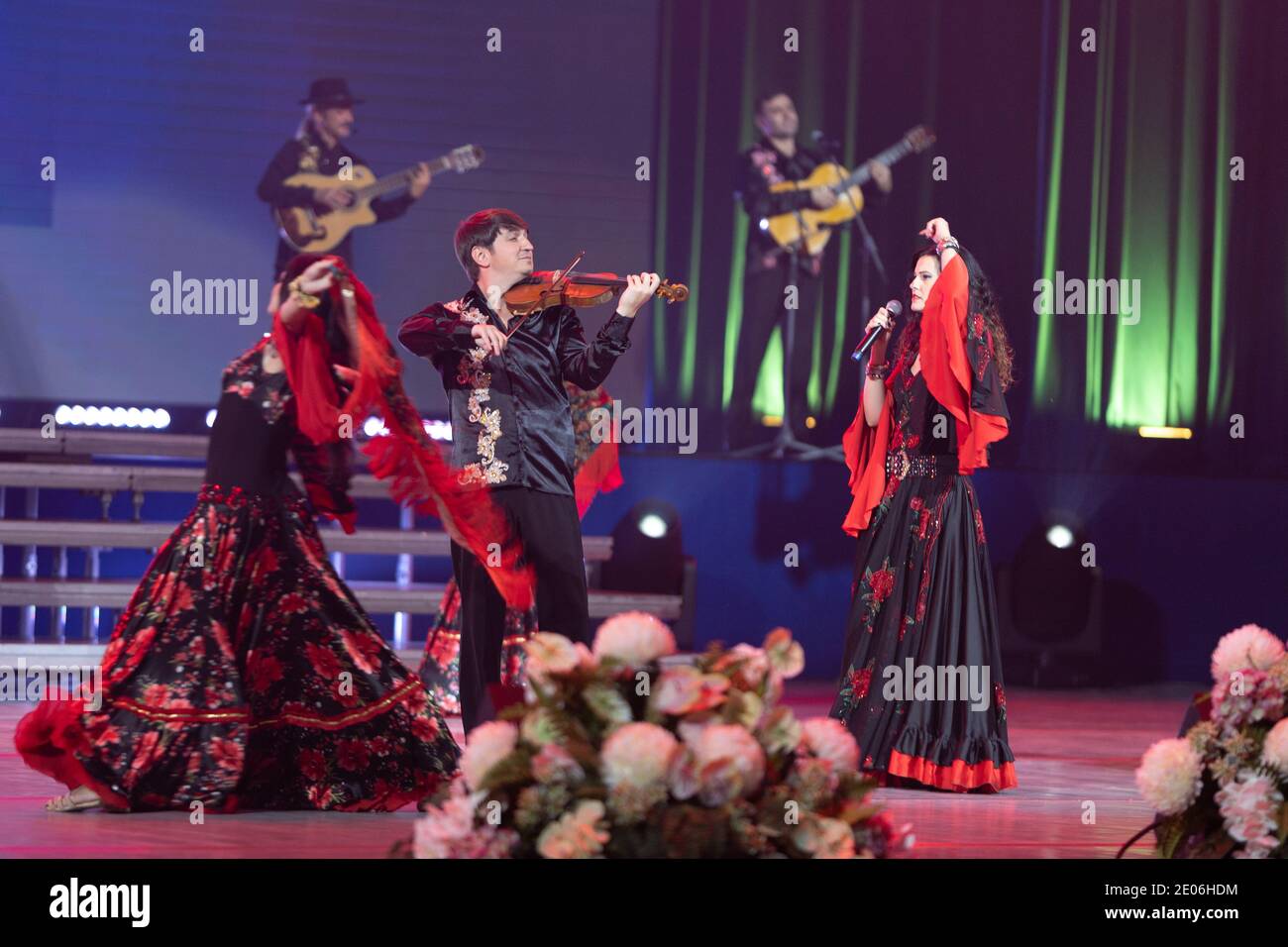 A team of musicians, singers and dancers in gypsy costumes singing and ...