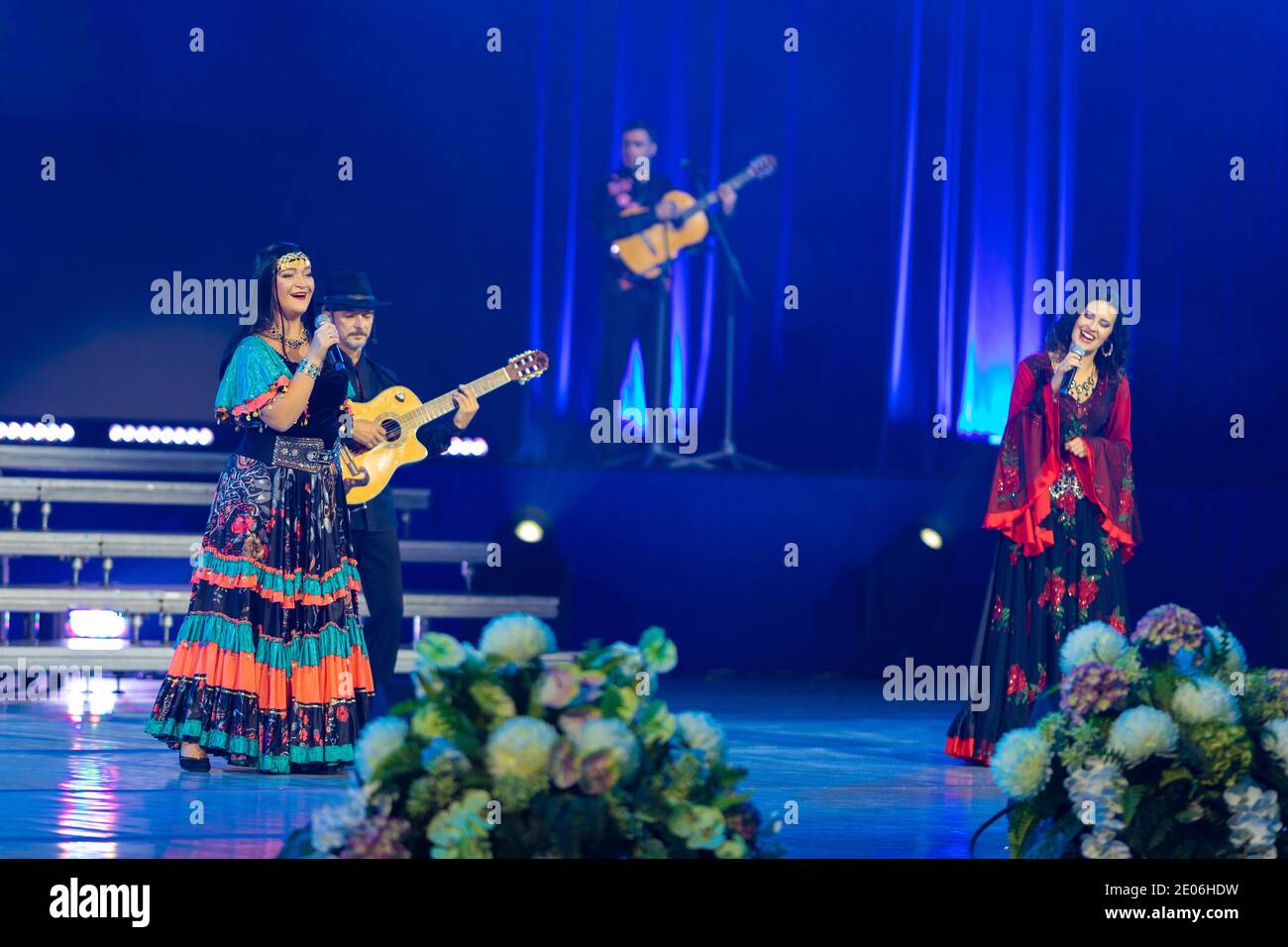 A team of musicians, singers and dancers in gypsy costumes singing and ...
