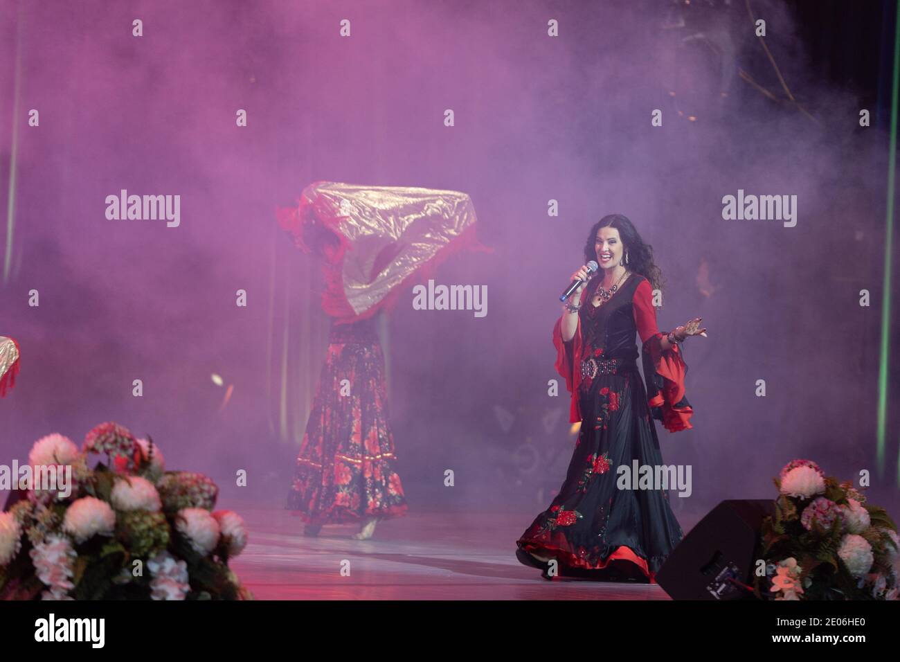 A team of musicians, singers and dancers in gypsy costumes singing and ...