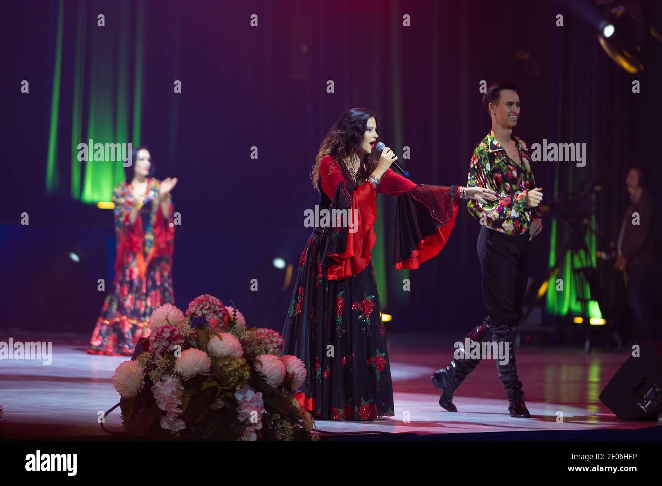 A team of musicians, singers and dancers in gypsy costumes singing and ...