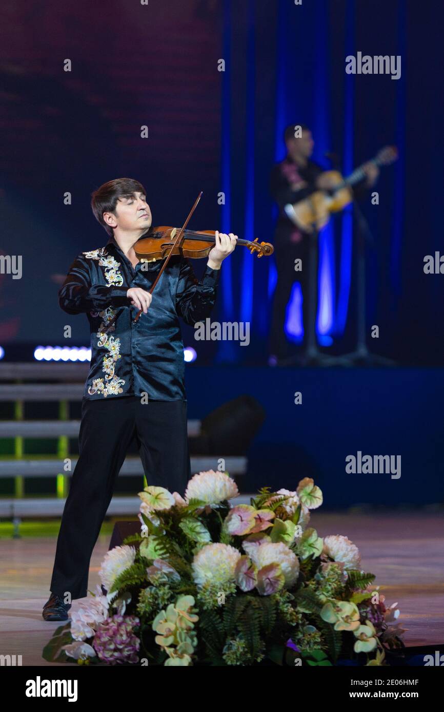 A team of musicians and singers perform on stage in front of the ...