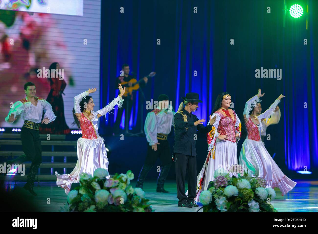 A team of musicians and singers perform on stage in front of the ...