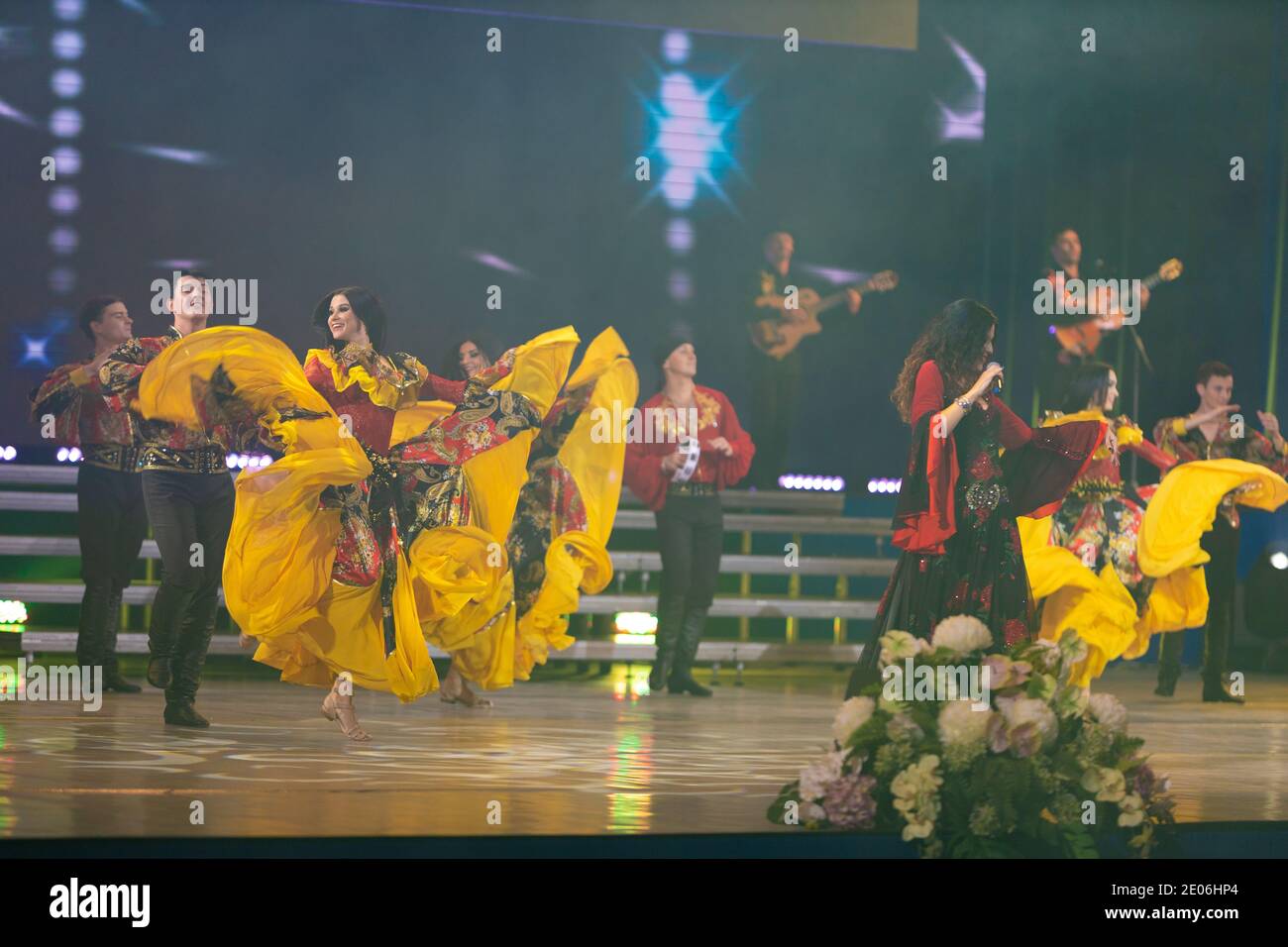 A team of musicians and singers perform on stage in front of the ...