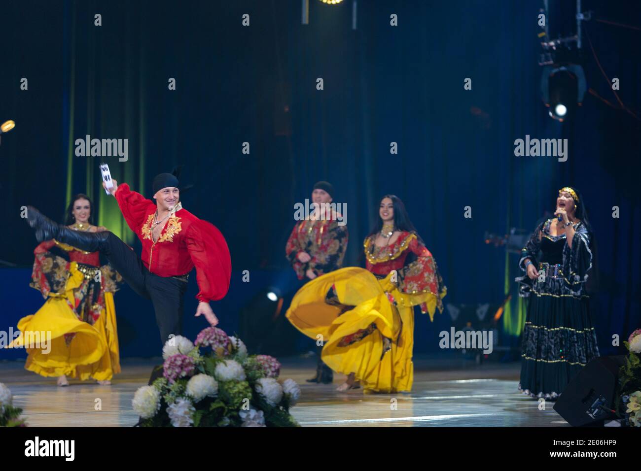 A team of musicians and singers perform on stage in front of the ...