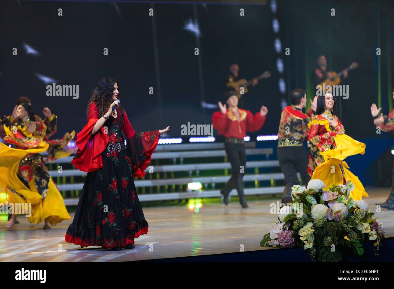 A team of musicians and singers perform on stage in front of the ...